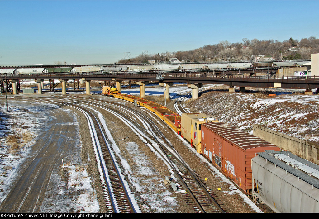 HZGX 169 trails on the end of a freight train.